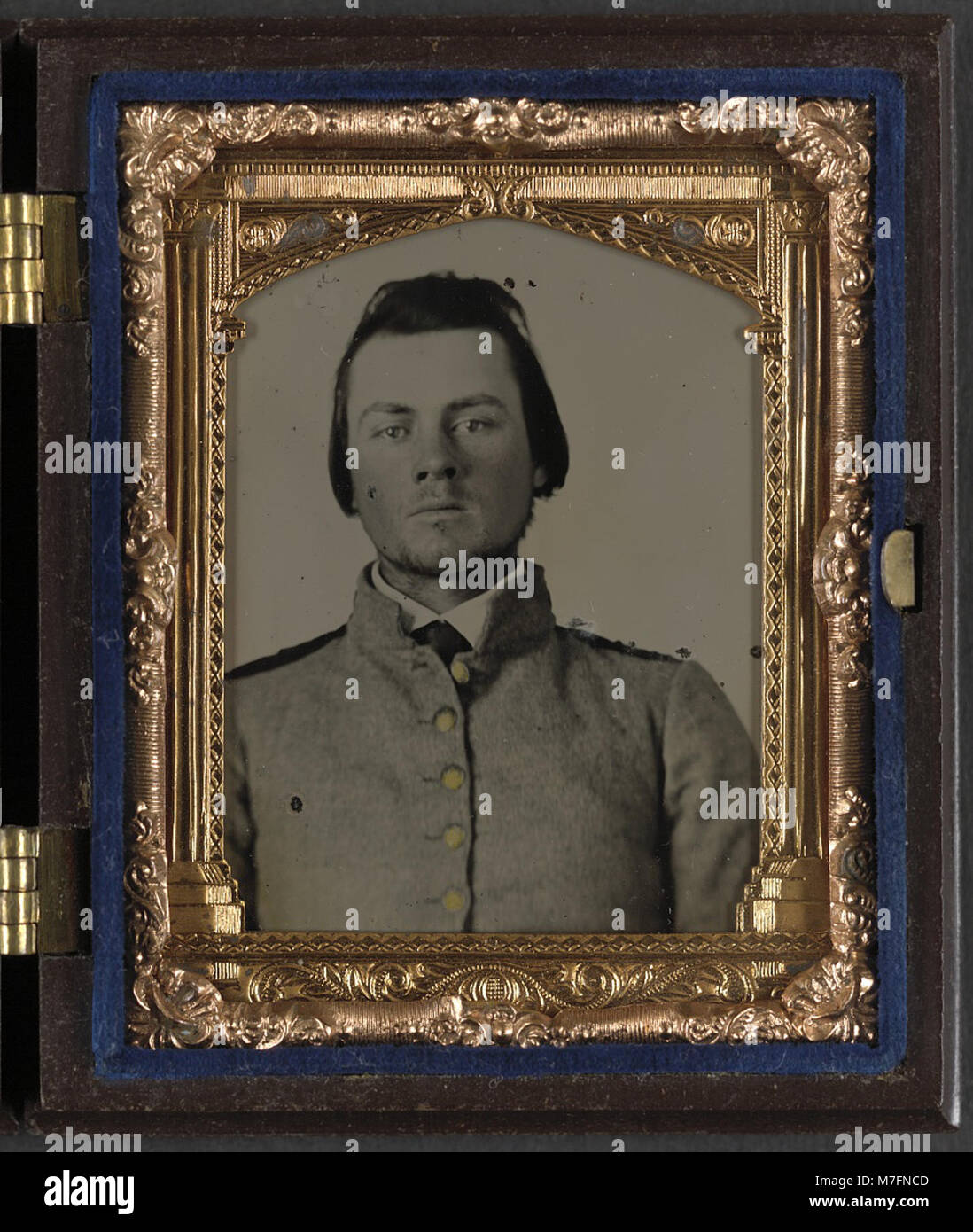 An unidentified soldier is shown wearing a Confederate uniform ...