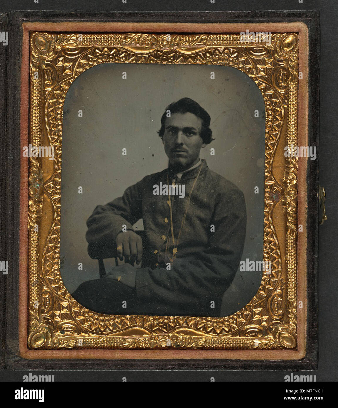 This image depicts an unidentified soldier in a Confederate uniform ...