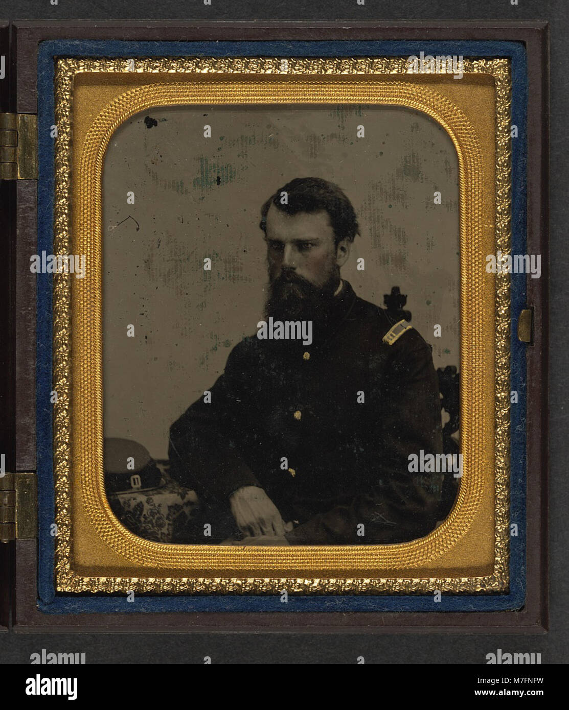 An unidentified soldier in a Union captain's uniform, resting his arm ...