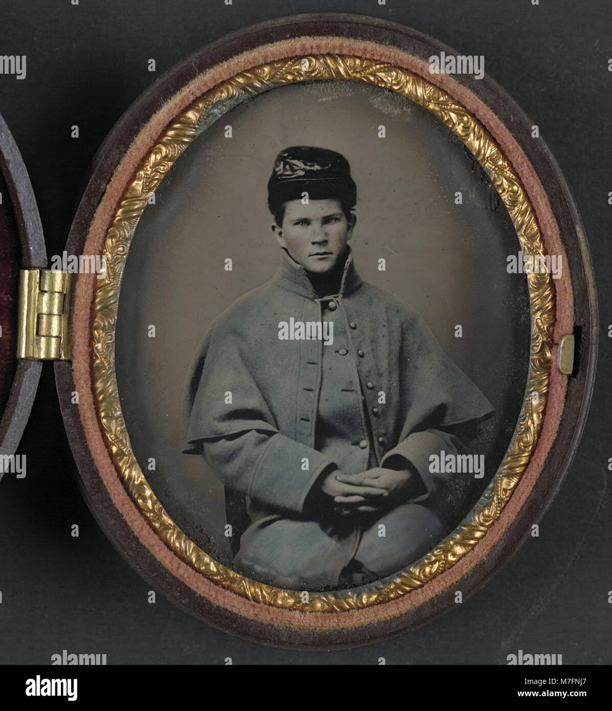 A photograph of an unidentified soldier wearing a Union great coat ...