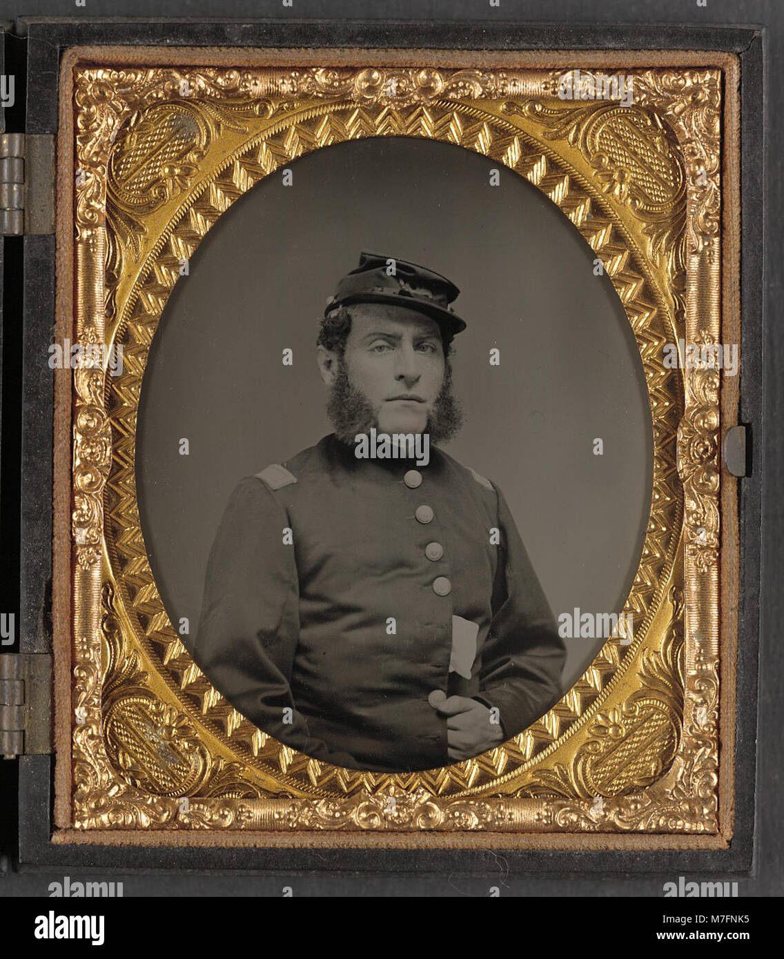 This photograph shows an unidentified soldier wearing a Union officer's ...