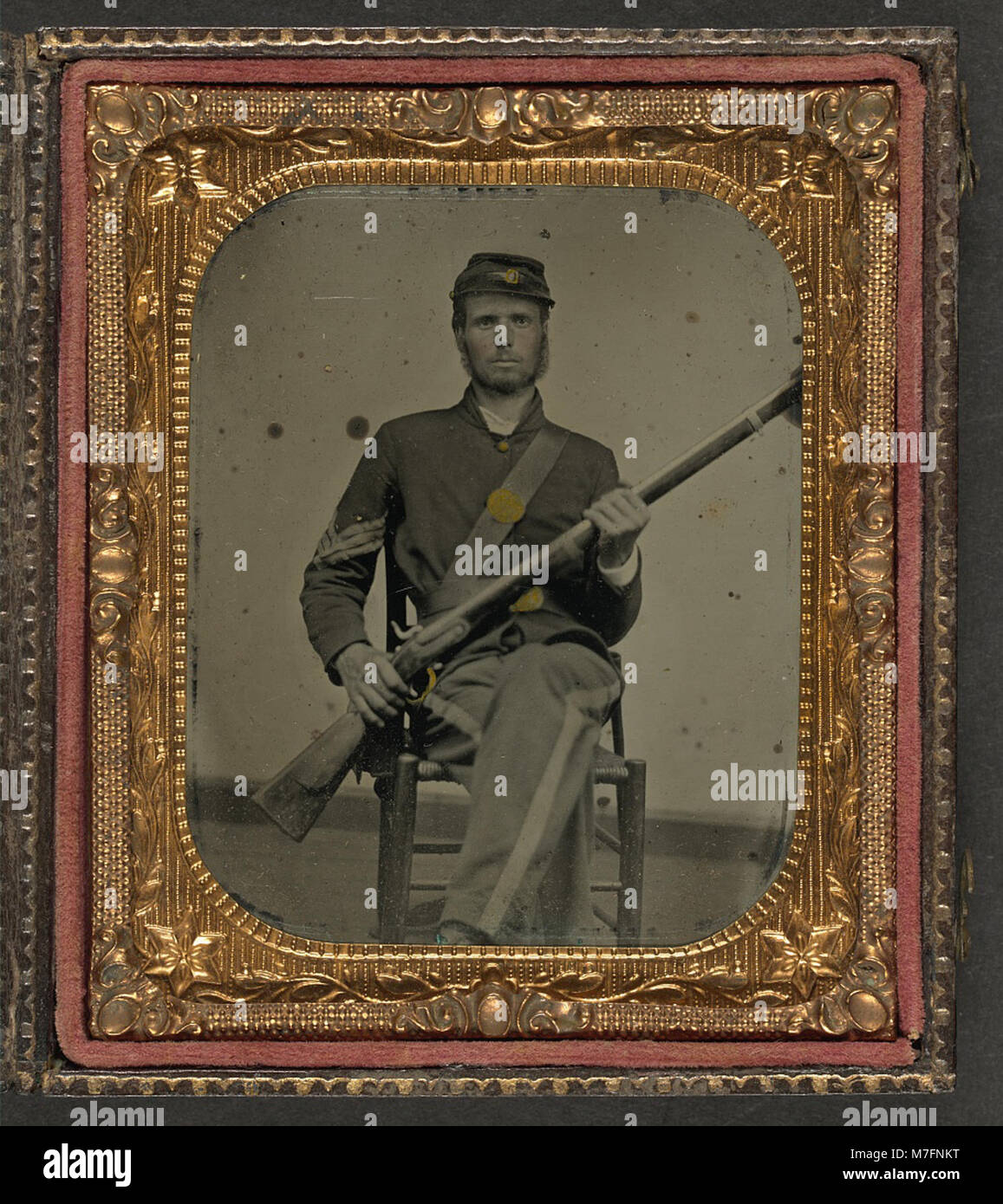 An image of an unidentified Union Army sergeant seated while holding a ...