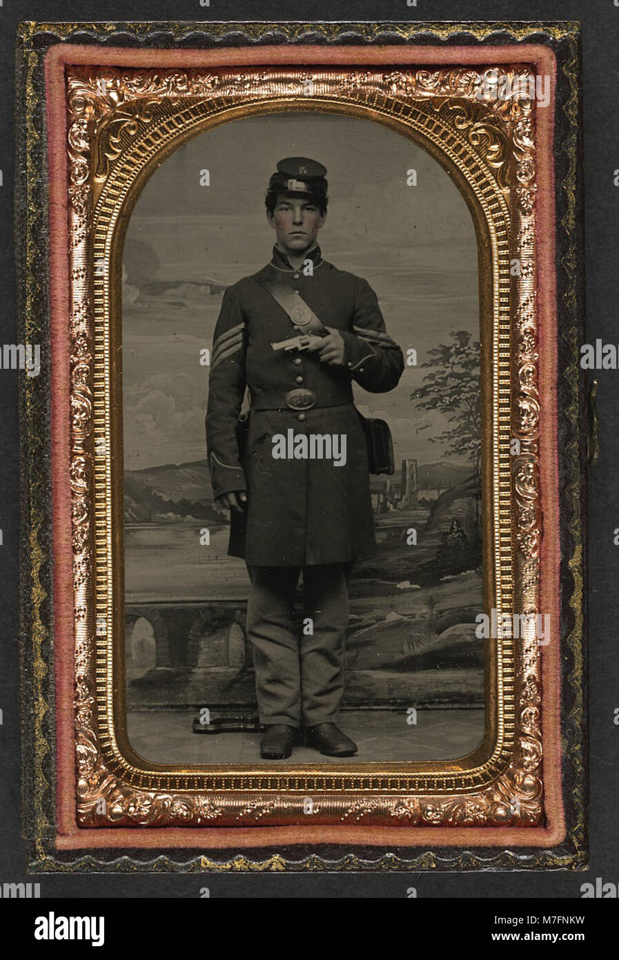 A Union sergeant in Civil War uniform, standing with revolver and ...