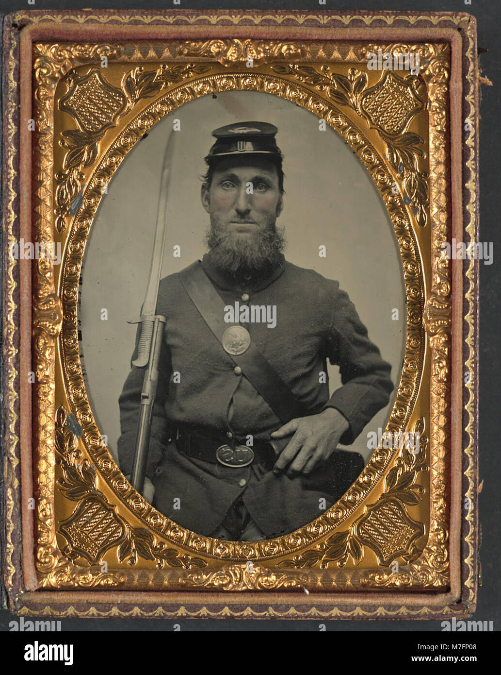 A portrait of an unidentified Union soldier, shown in uniform with a ...