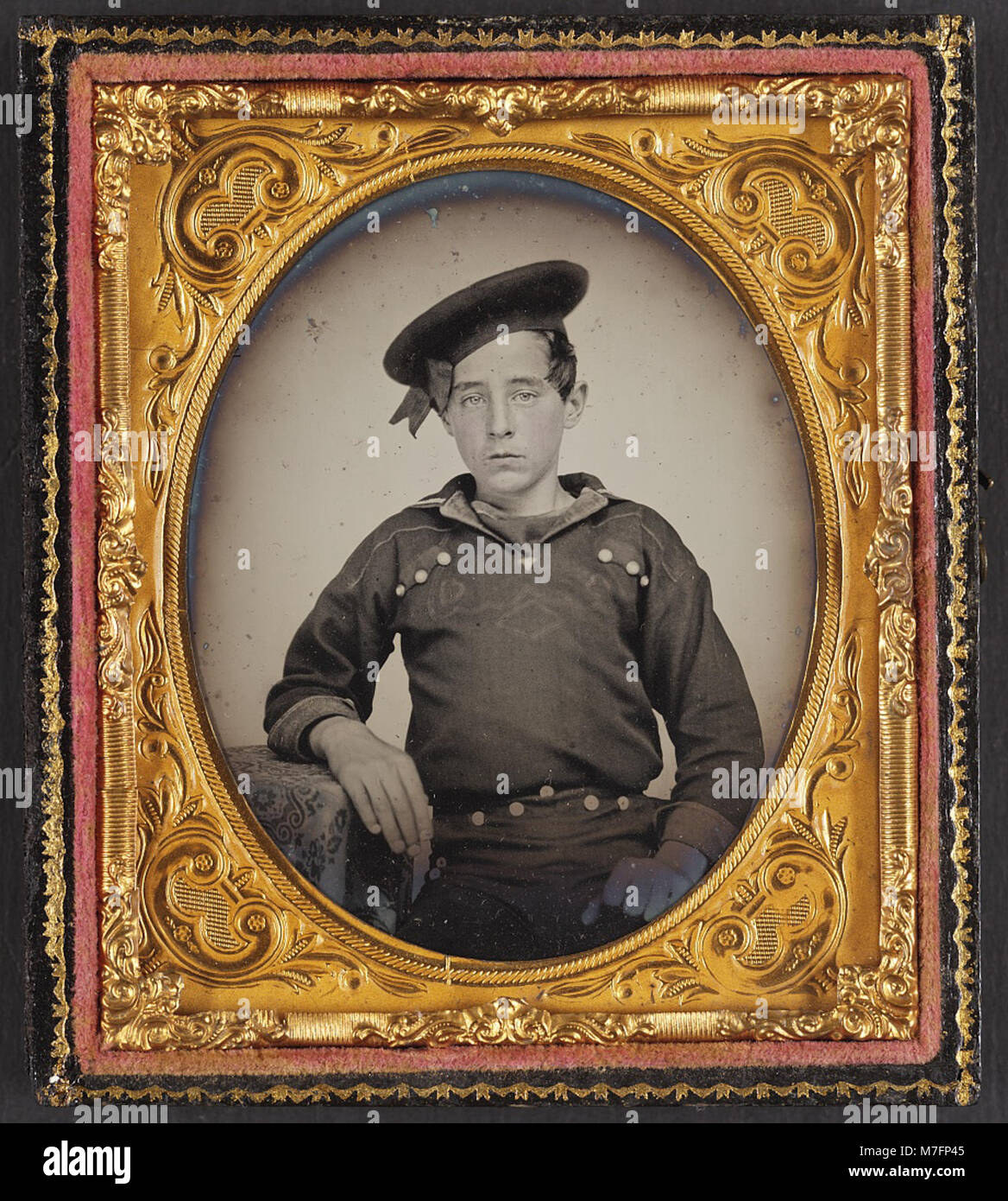 A young sailor, dressed in a Union uniform, is shown in this image. The ...