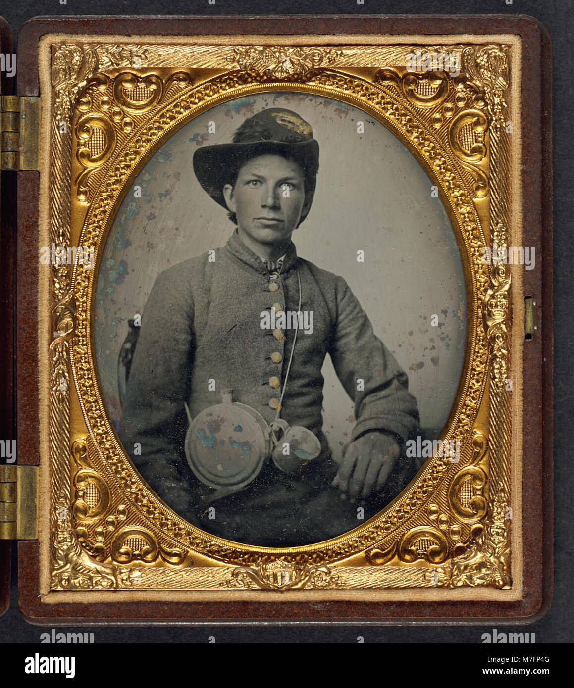 A photograph of an unidentified young Confederate soldier dressed in a ...