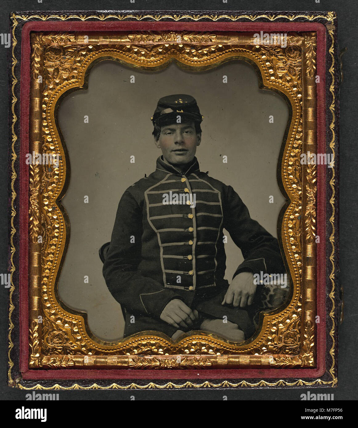 This photograph depicts a young Union soldier wearing a musician's ...