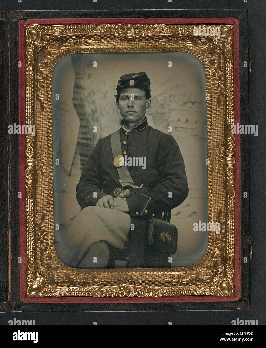 This photograph features a young Union soldier, dressed in full ...