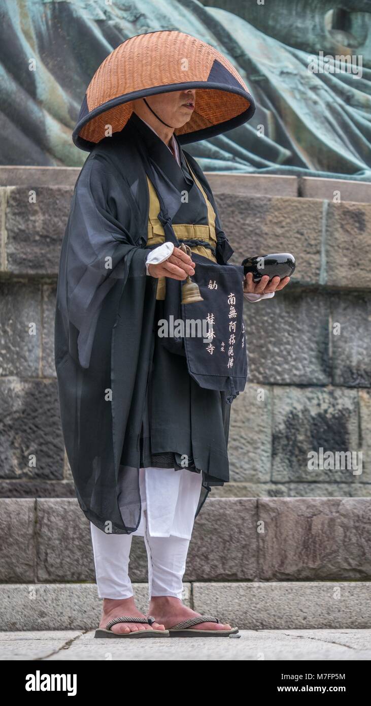 Japanese Buddhist pilgrim dressed in traditional bowl shaped straw hat ...