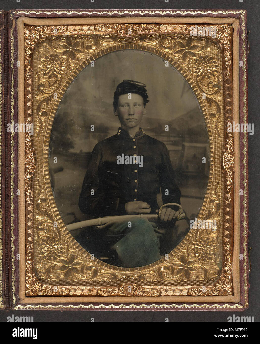 A photograph of an unidentified young soldier wearing a Union uniform ...