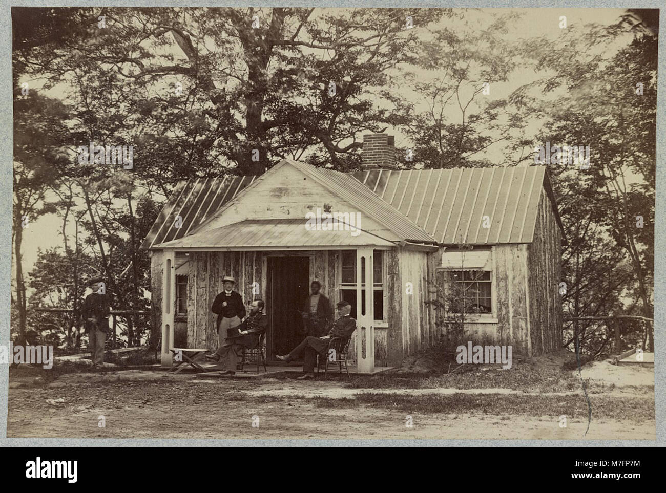 A photograph showing Union Army soldiers seated on a porch with three ...