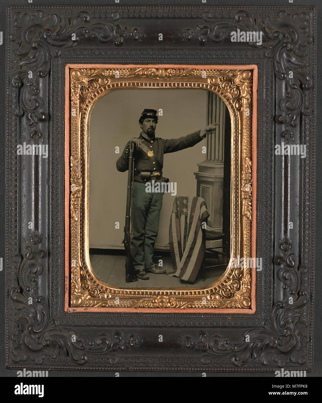 An image of a Union soldier in full uniform, holding a musket and an ...
