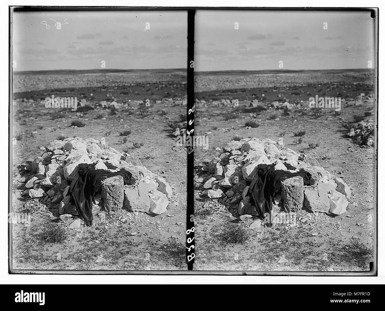 A photograph showing a grave covered with the garment of the deceased ...