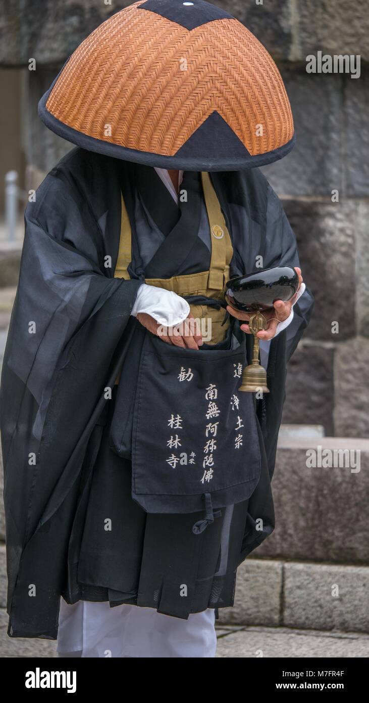 Japanese Buddhist pilgrim head concealed by bowl shaped straw hat ...