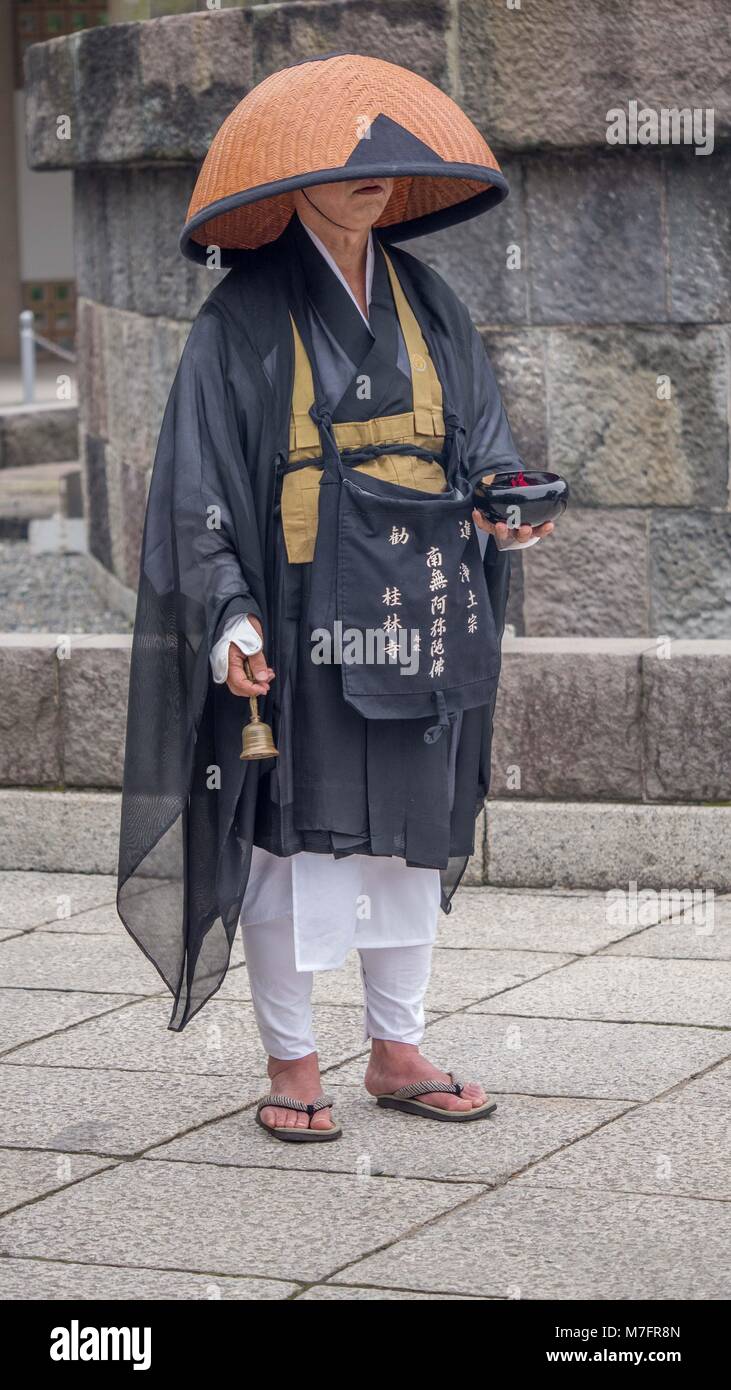 Japanese Buddhist pilgrim head covered in straw hat, mouth visible ...