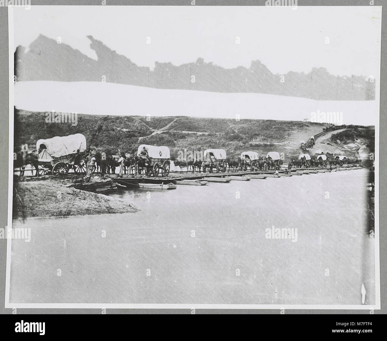 A depiction of a wagon train, possibly from the 19th century, capturing ...