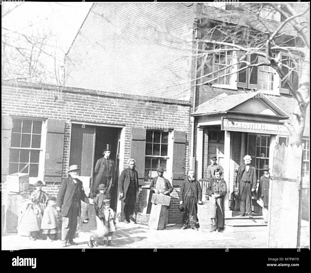 A group of people gathered in front of the office of the U.S. Christian ...