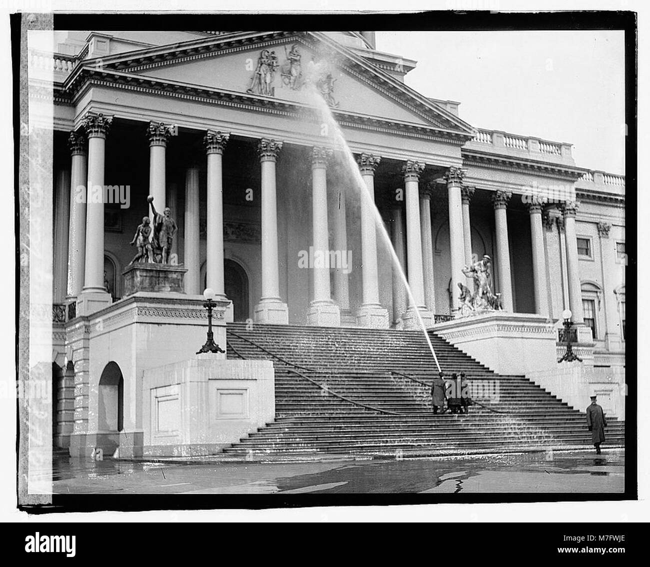 A historical photograph showing workers cleaning the exterior of the U ...
