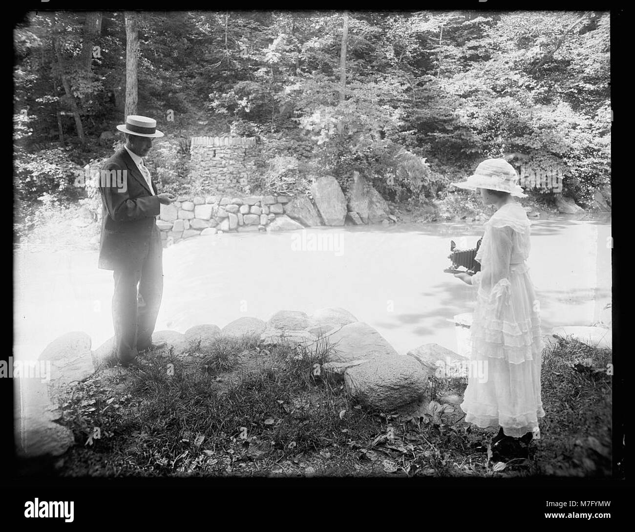 A photograph of a woman capturing an image of a man in a natural ...
