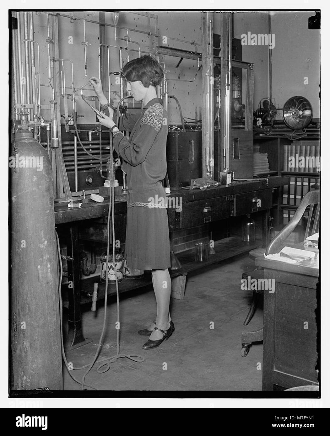 The photograph depicts a female scientist, emphasizing her role in the ...