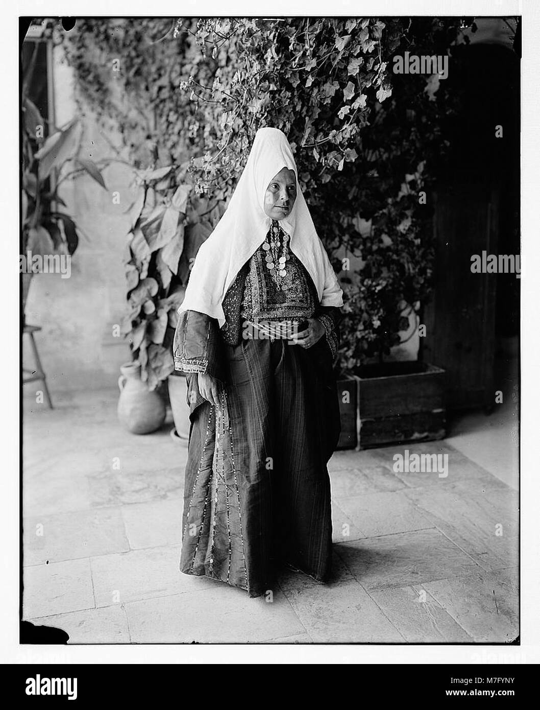 A woman is depicted wearing a traditional dowry necklace, highlighting ...