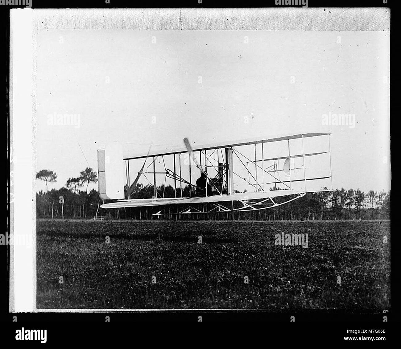This photograph features a Wright machine, an early aircraft model. The ...