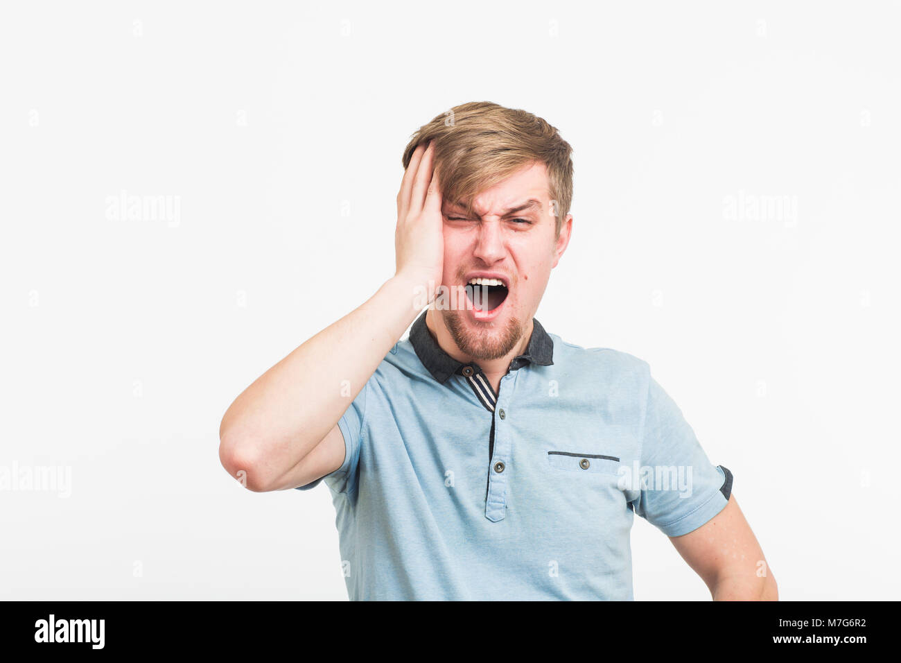 Stressed Young Man Clutching the Head in white background Stock Photo ...
