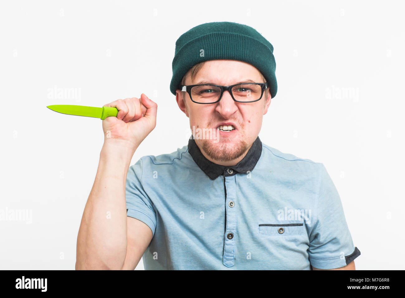 Young angry man holding a knife isolated on a white background Stock ...