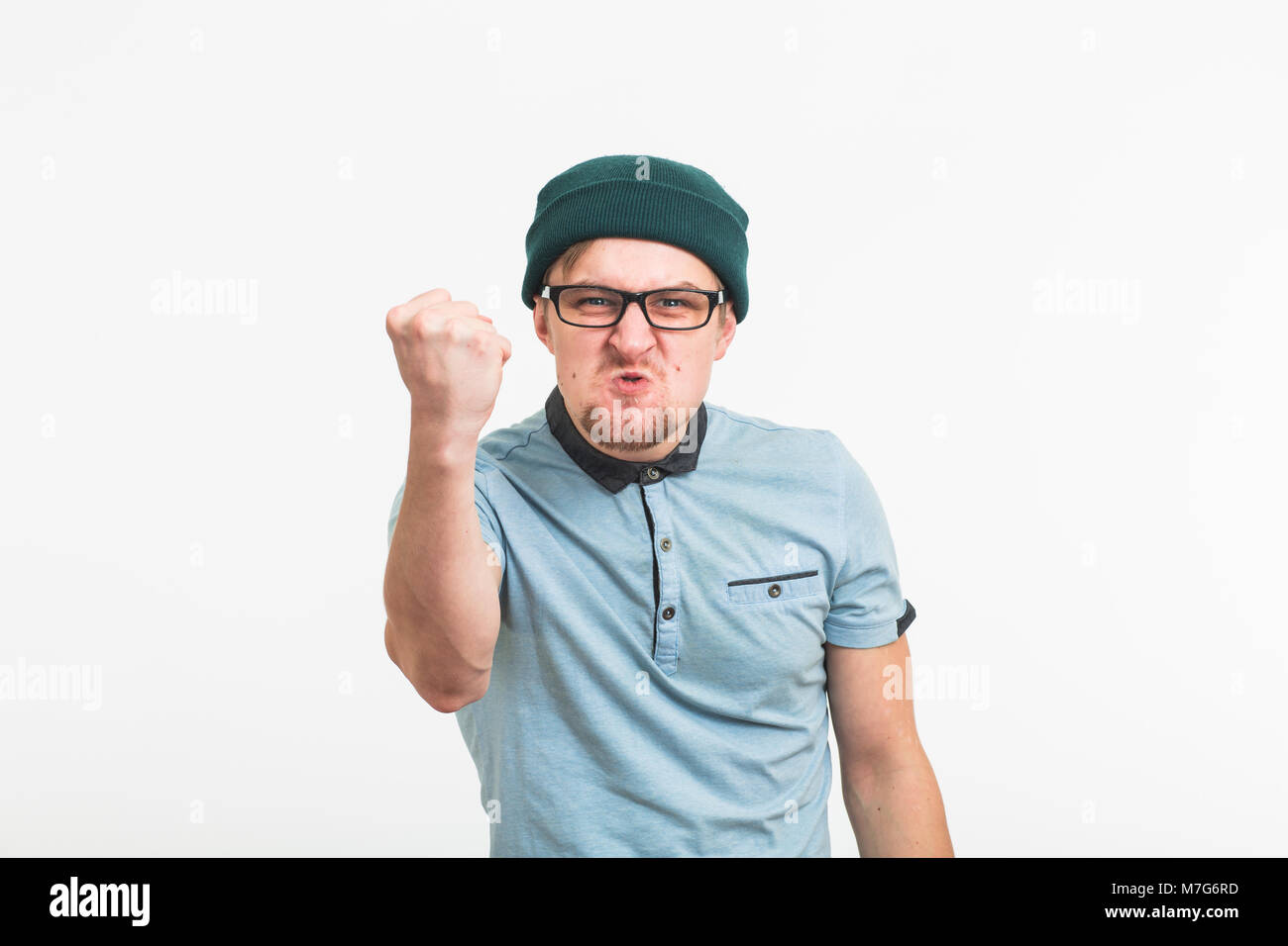 Angry aggressive man with ferocious expression on white background ...