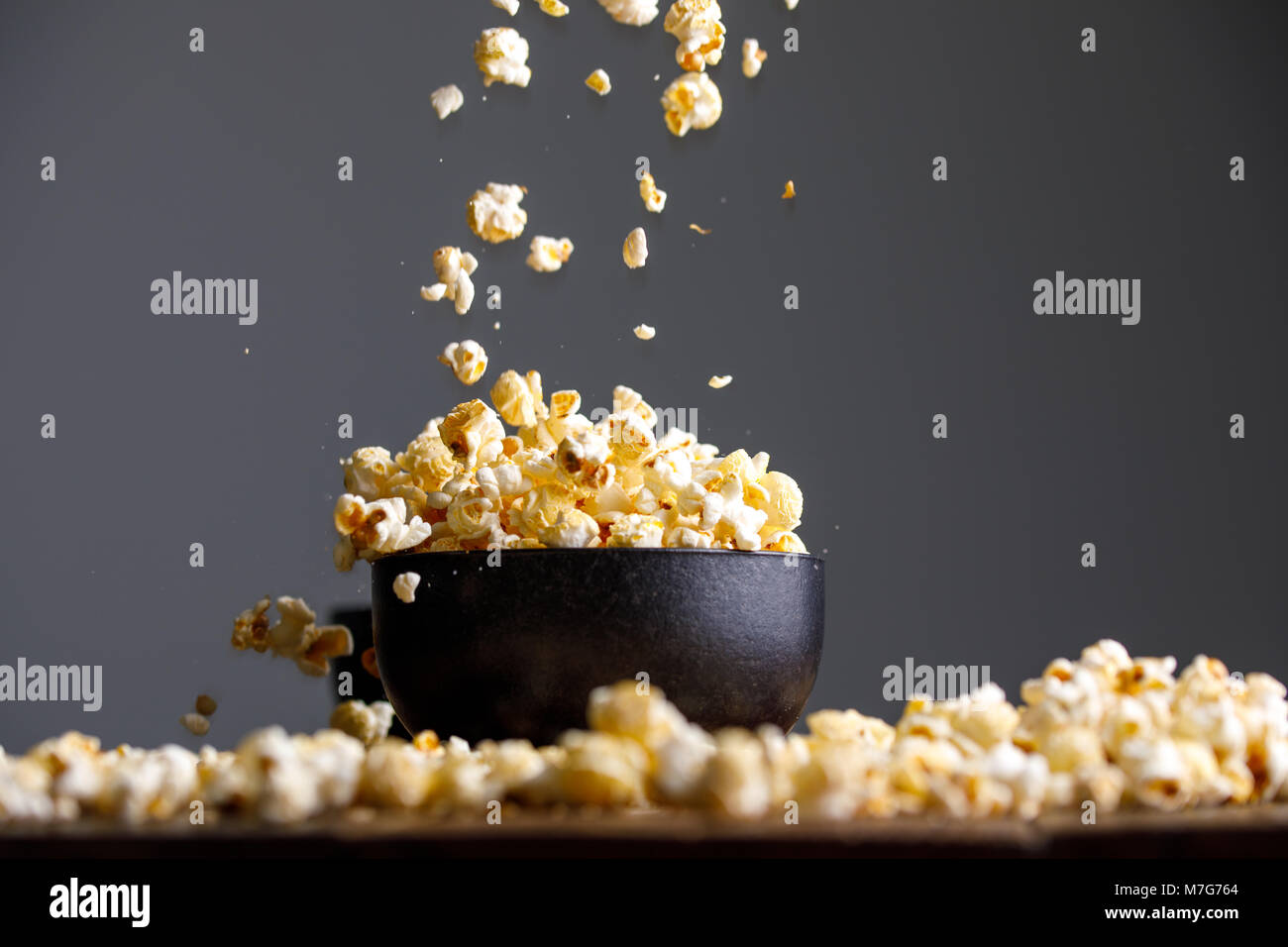Levitating popcorn around a ceramic cup. Appetizing still life Stock ...