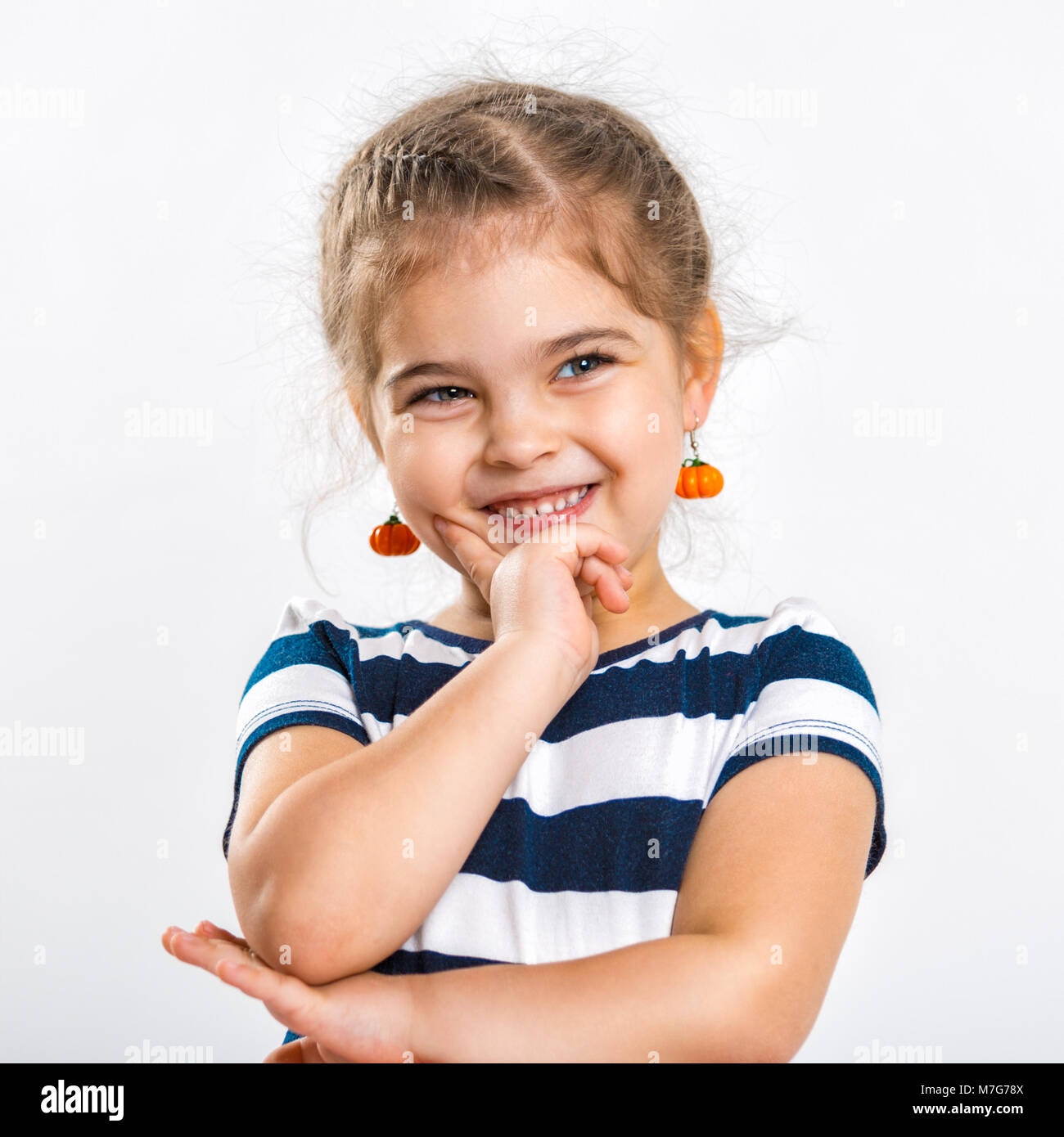 Portrait of a beautiful little smiling girl. Child on a gray background ...
