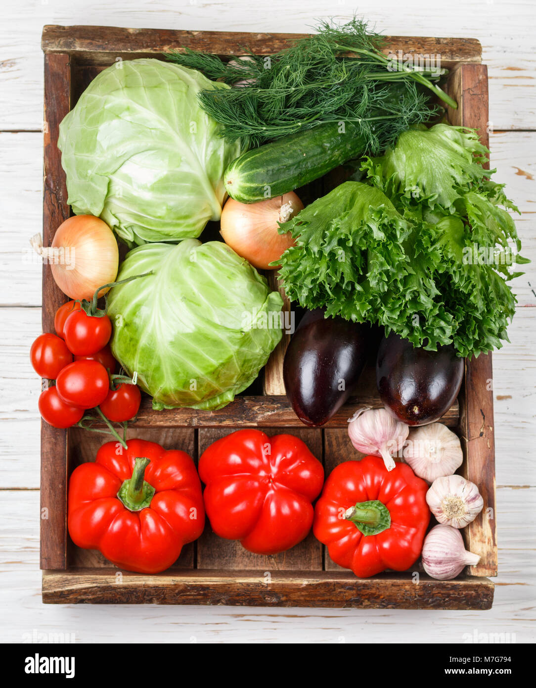 Fresh organic vegetables in wooden crate - cabbage, tomatoes, bell ...