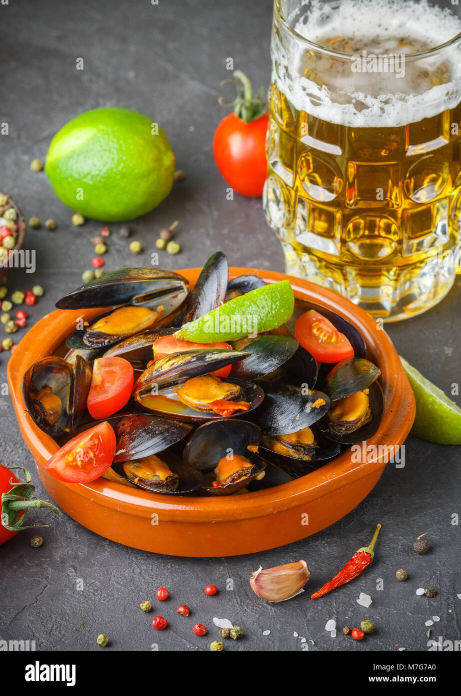 Mussels in shells with tomatoes and spicy sauce of chili peppers and ...