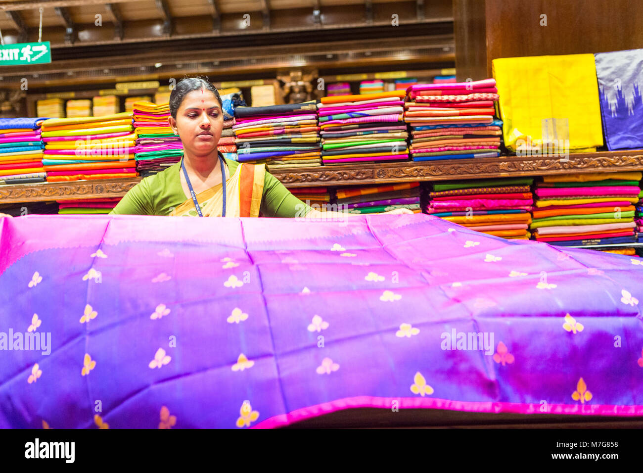 women folding material at pothys store in trivandrum Stock Photo - Alamy