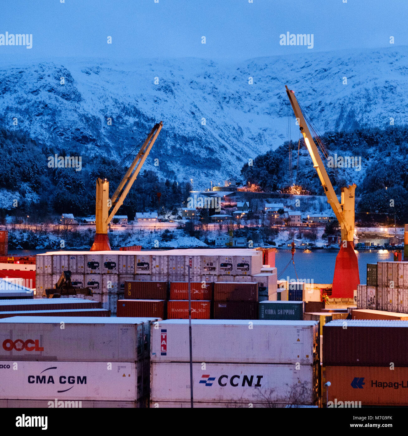 Shipping containers in Alesund port, Norway with backdrop of snow ...