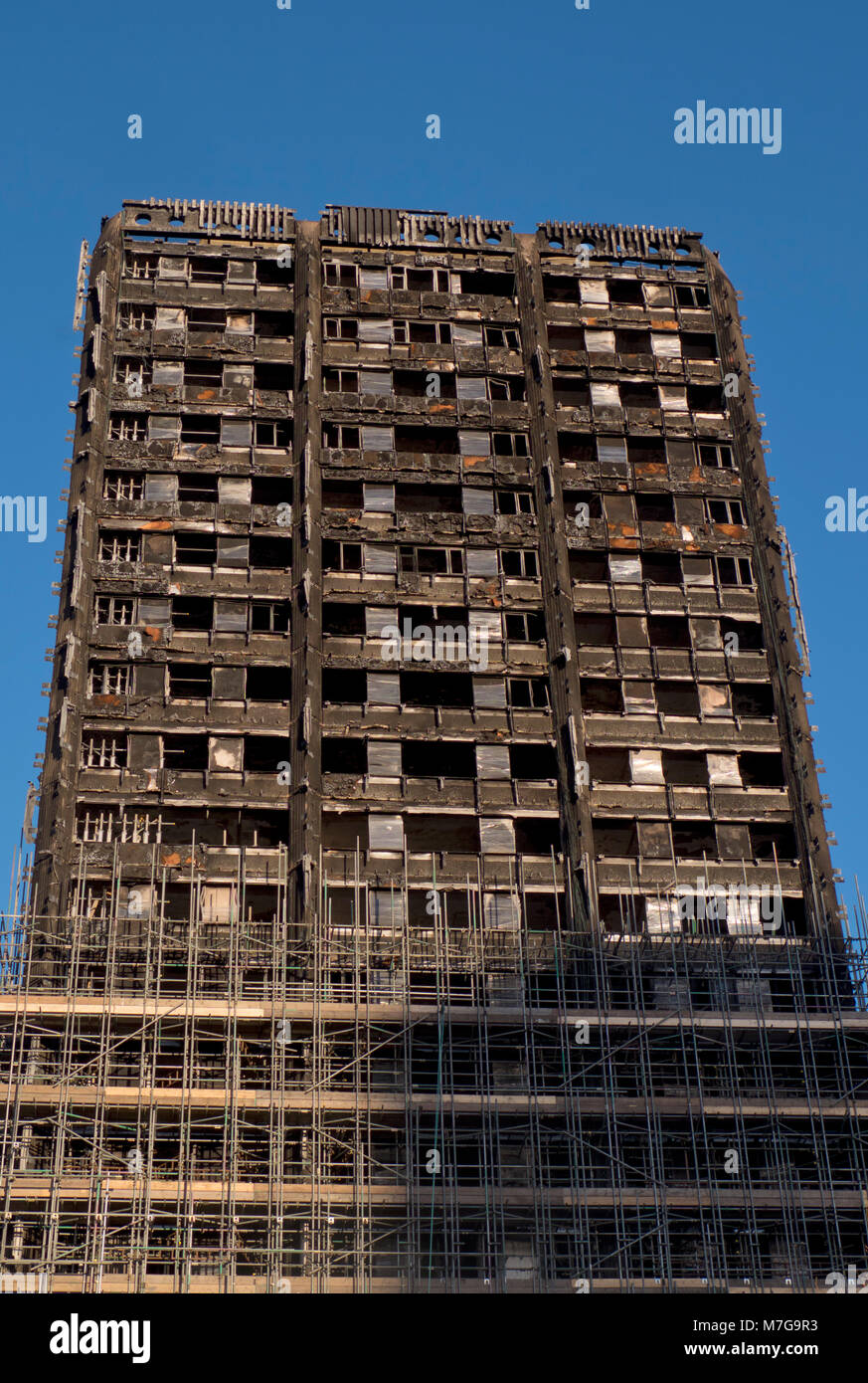 View of of burnt-out shell of Grenfell Tower housing with scaffolding ...