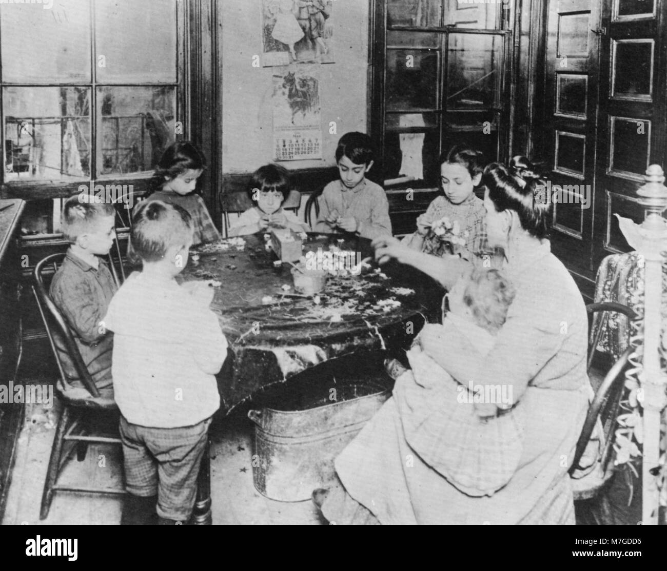 Jacob Riis captured a family making artificial flowers in this ...