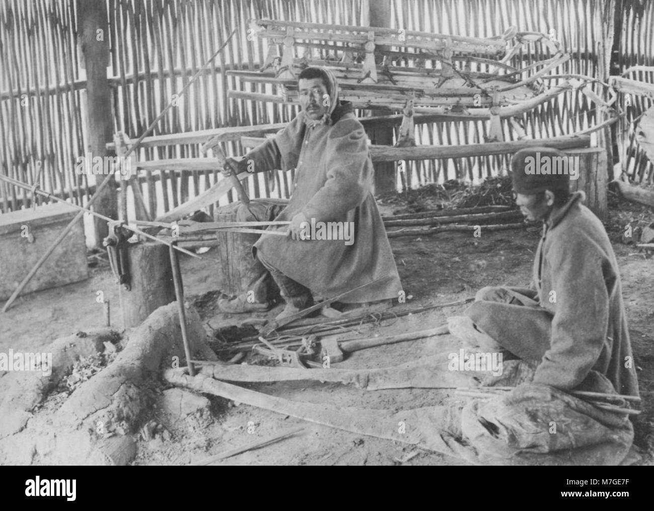 A Russian photograph depicting a blacksmith at work in a forge. The ...