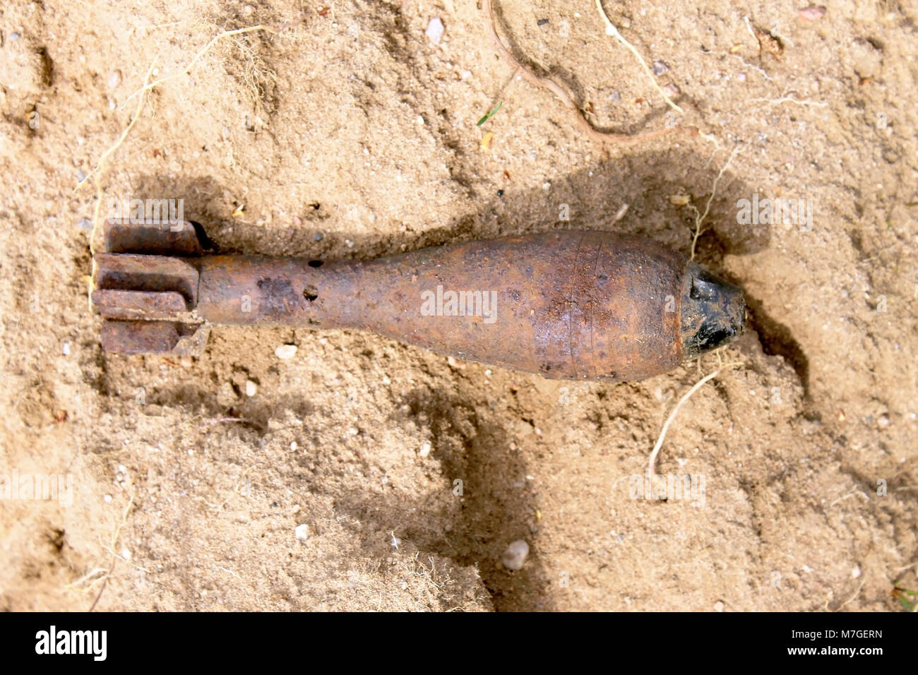 Old unexploded mortar shell grenade on the sand Stock Photo - Alamy