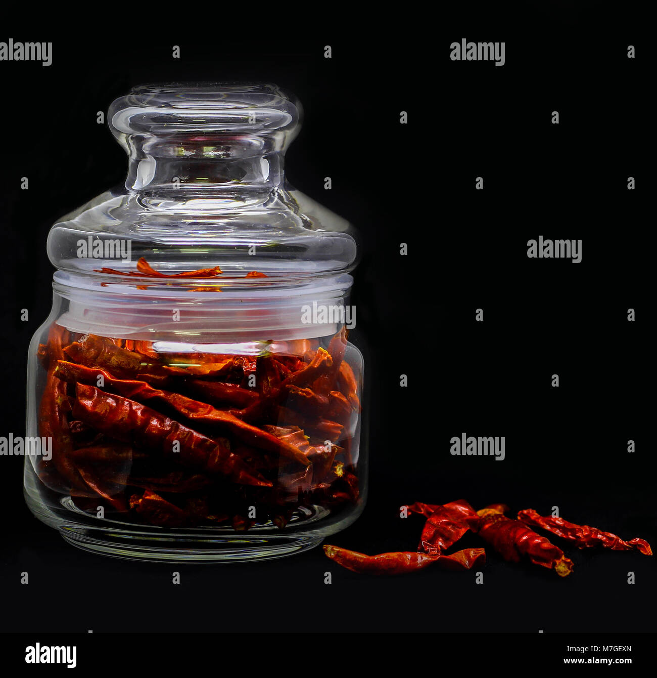 Dried Red Chilli In Glass Container in Black Background Stock Photo - Alamy
