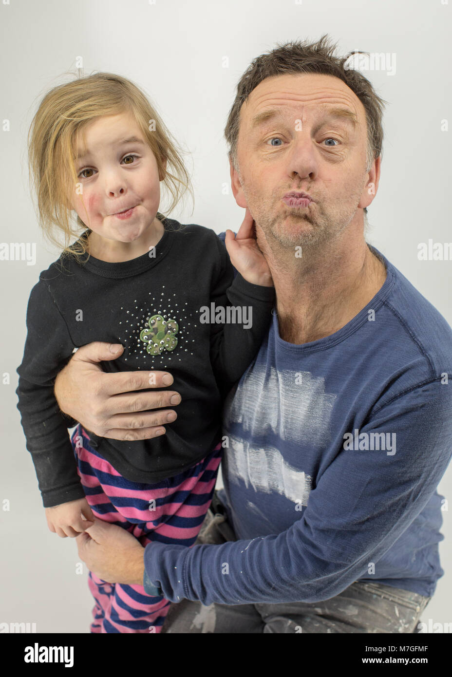 Dad and daughter making funny faces in studio Stock Photo - Alamy
