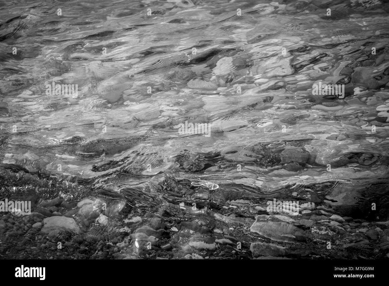 Sea stones or the wet smooth black stone on the beach as background ...