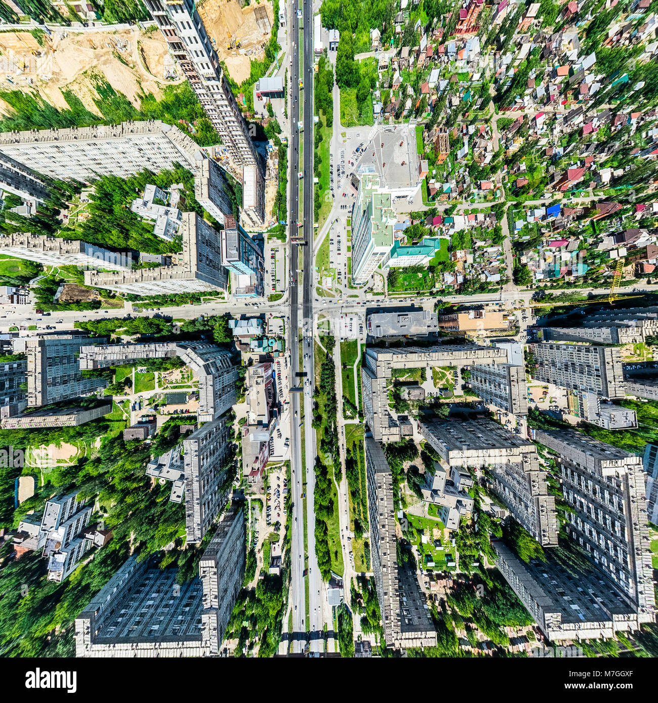 Aerial city view with crossroads and roads, houses, buildings, parks ...