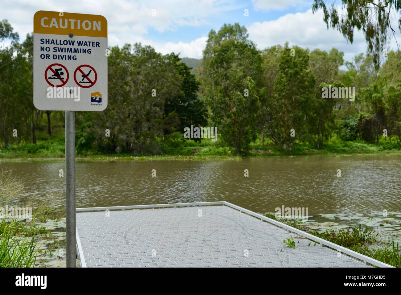 Caution shallow water no diving or swimming sign, Apex Park, Riverway ...