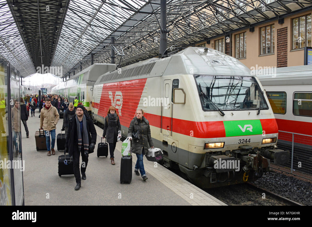 Passengers alight from a double decker train with Sr2 class locomotive ...