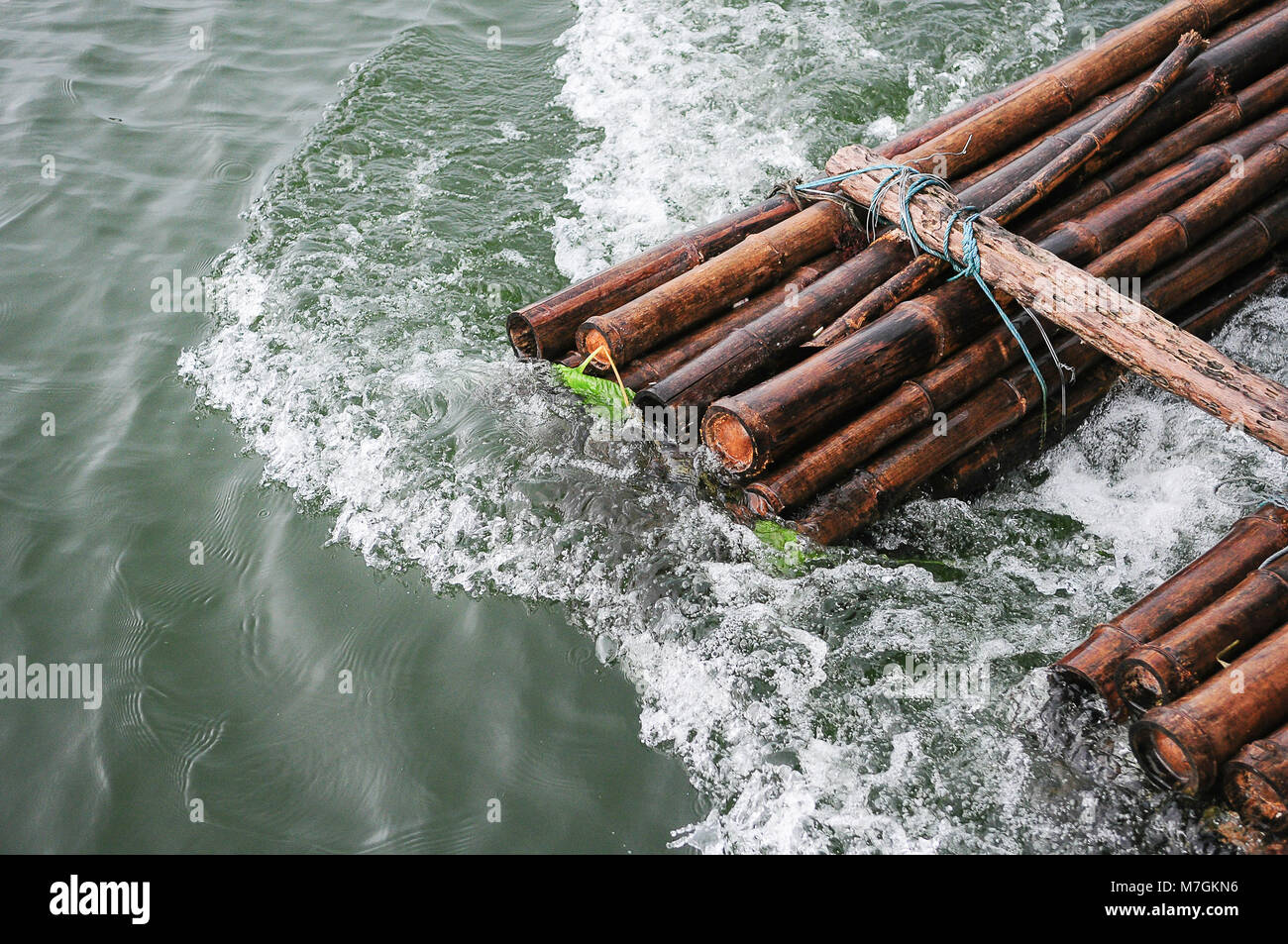 Part of houseboat raft made from bamboo floating on the water over the ...