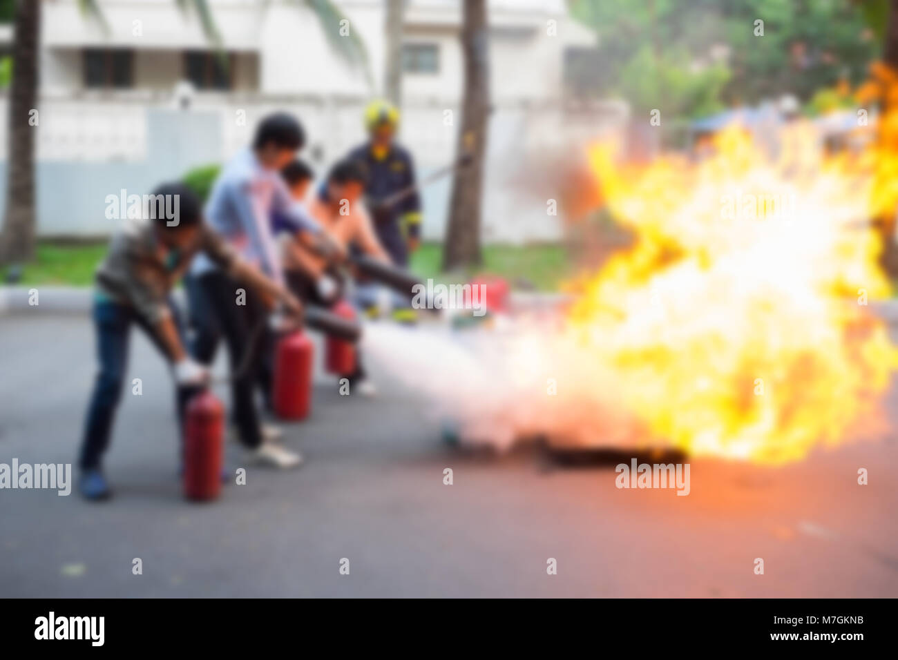 Abstract blur people practicing how to stop fire in fire fighting ...