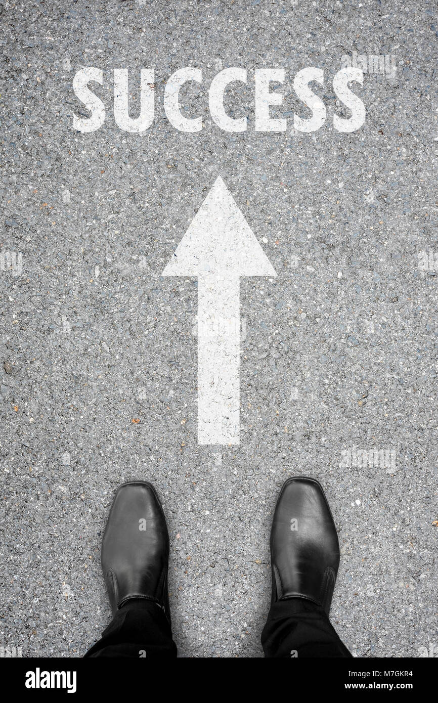 Businessman in black shoes standing on the road to success. Direction ...