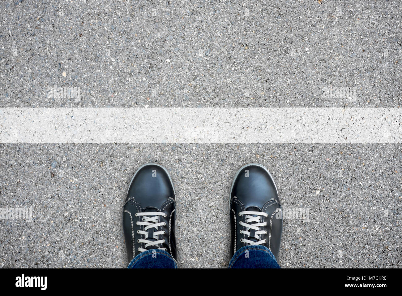 Black casual shoes standing at the white line making decision - stop ...