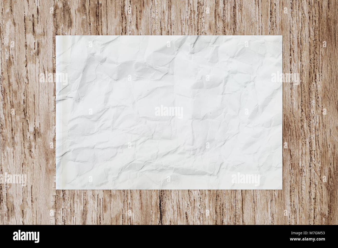 White blank crumpled paper on wooden table, creased paper texture for ...